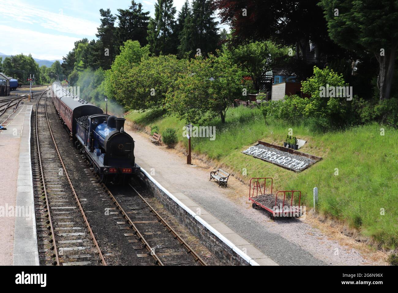 Old steam train arriving in station Stock Photo - Alamy
