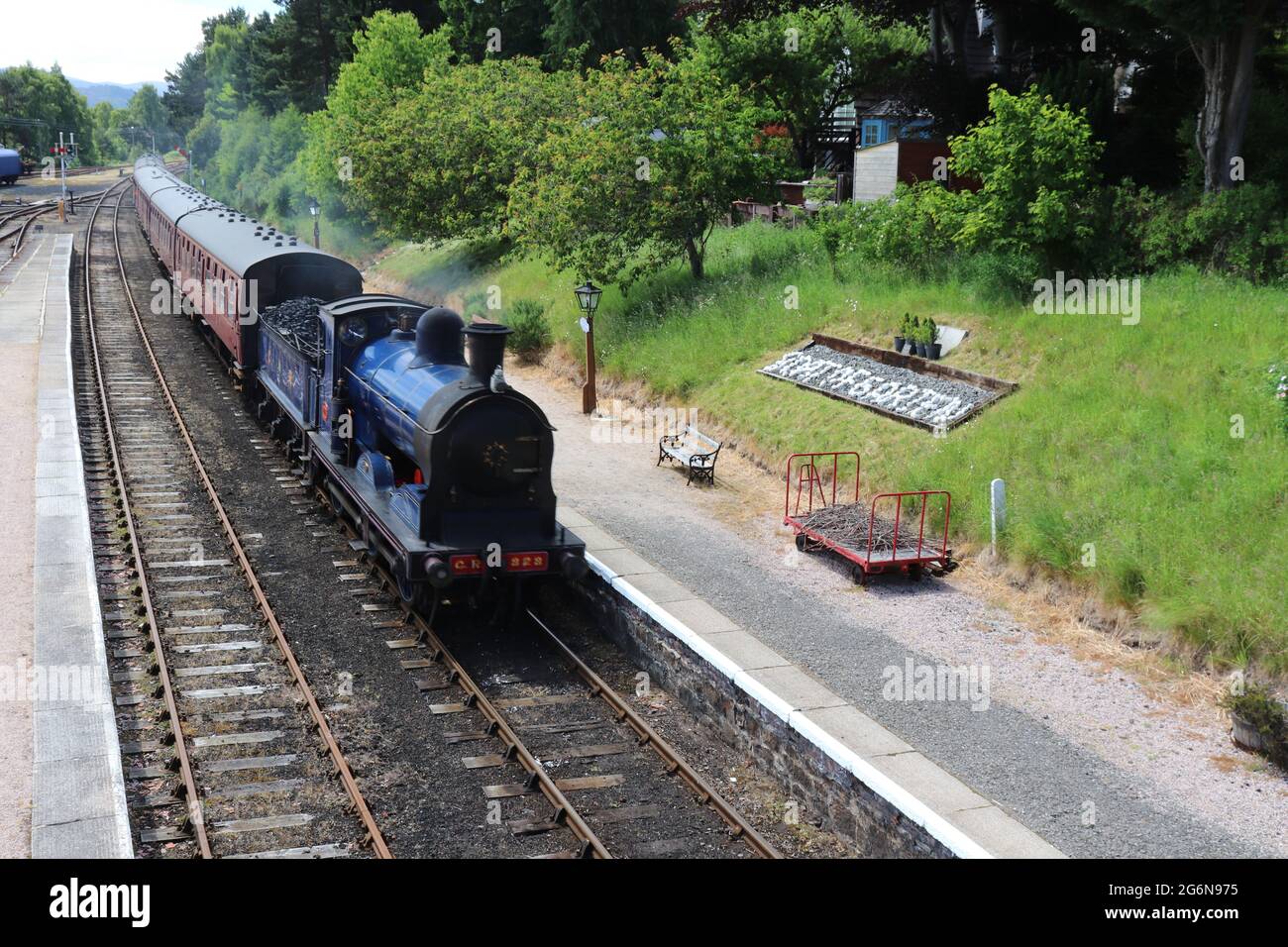 Old steam train arriving in station Stock Photo - Alamy