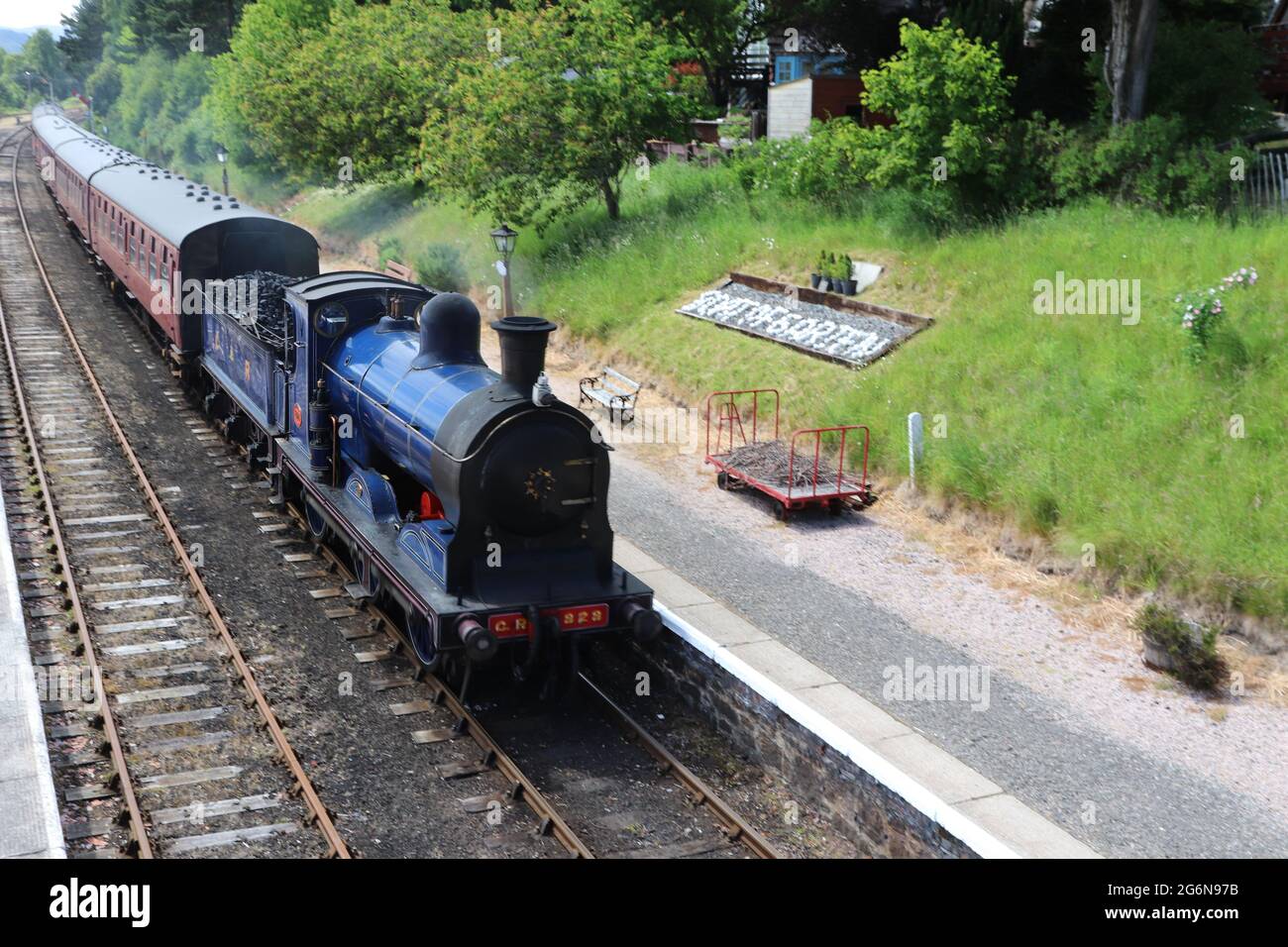 Old steam train arriving in station Stock Photo - Alamy