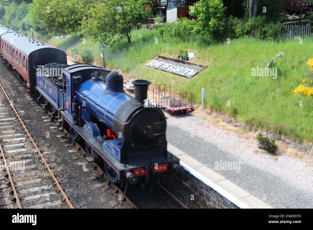 Old steam train arriving in station Stock Photo - Alamy