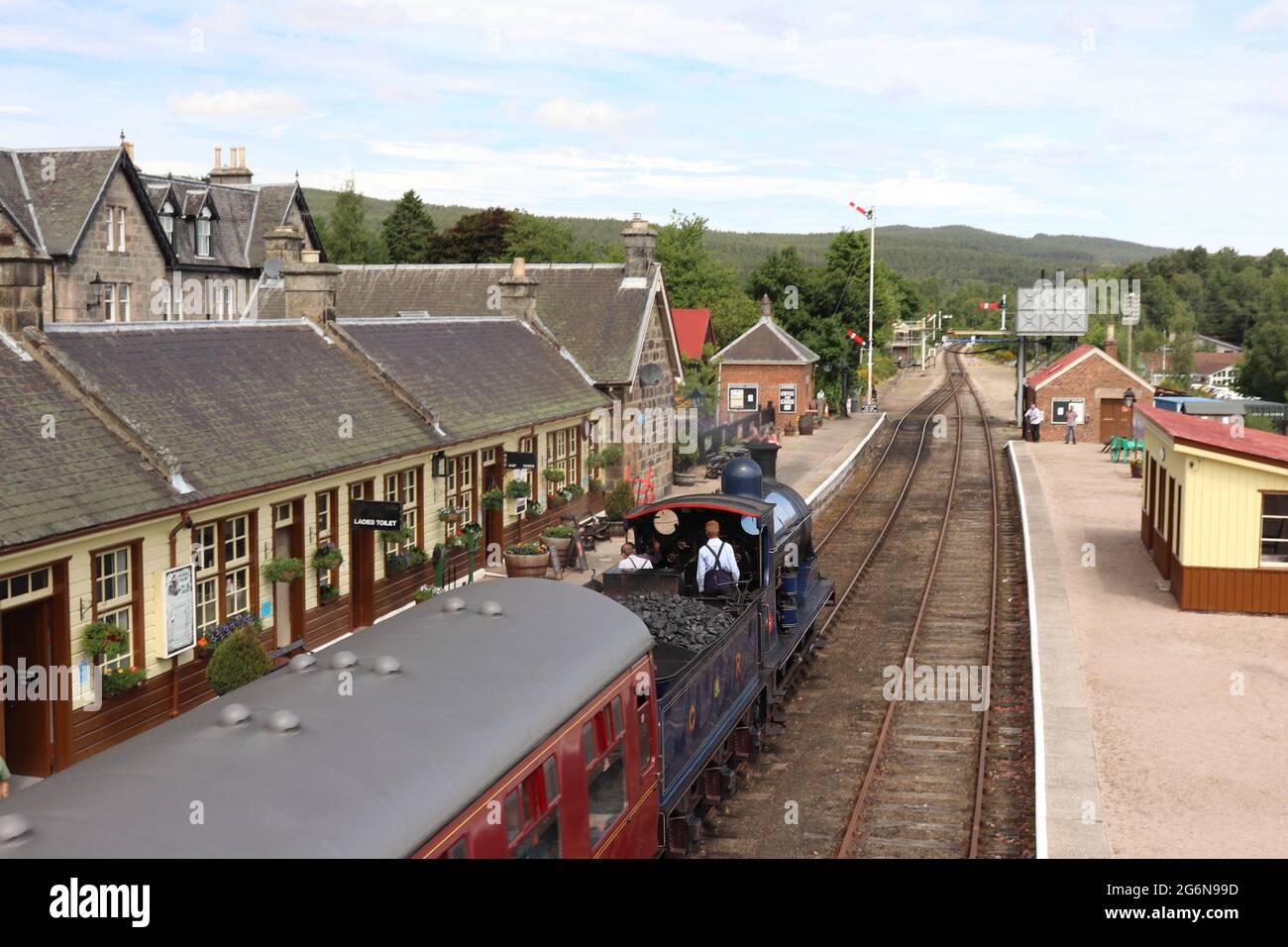 Old steam train arriving in station Stock Photo - Alamy
