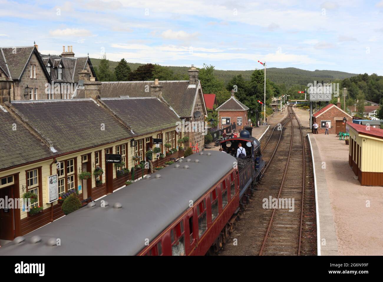 Old steam train arriving in station Stock Photo - Alamy