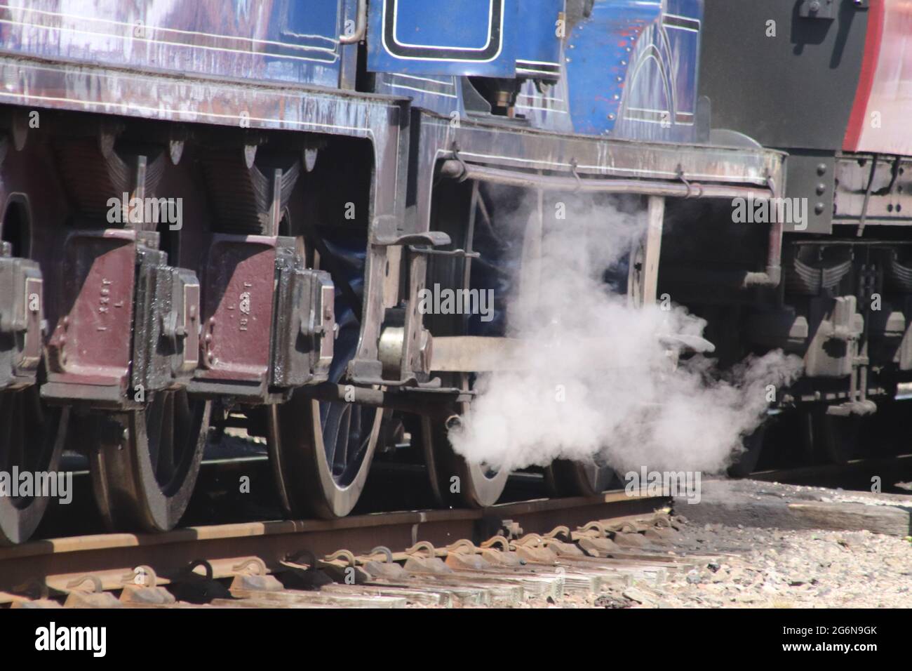 Old steam train arriving in station Stock Photo - Alamy