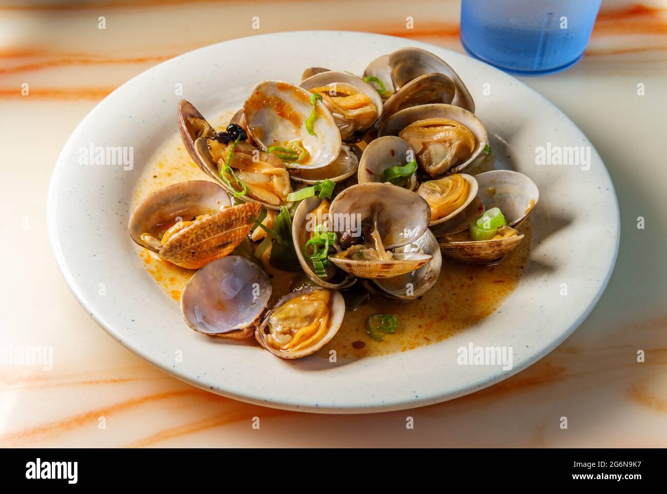 Chinese clams with black bean sauce garnished with green onions Stock ...