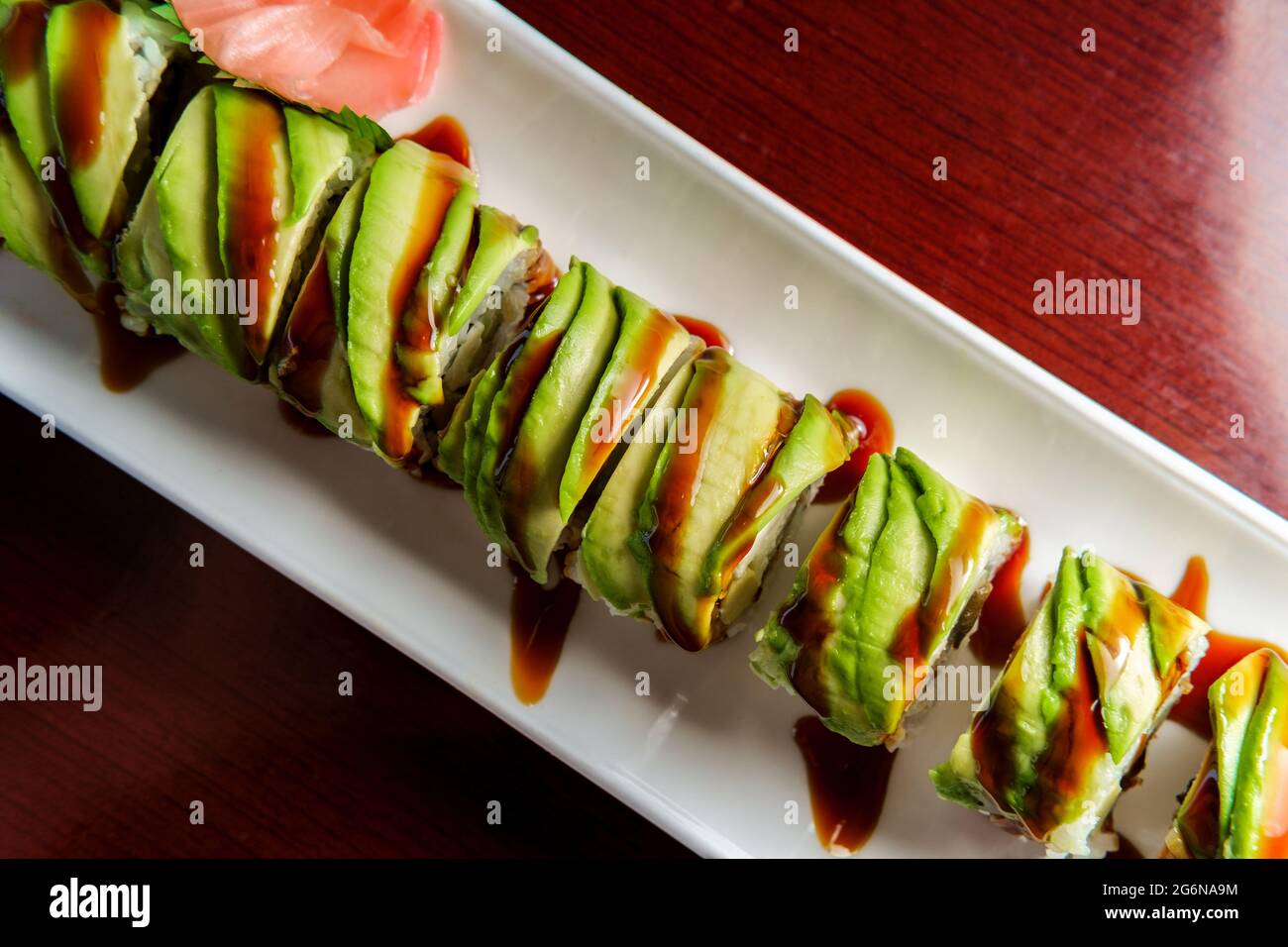 Japanese eel avacado dragon roll with wasabi and pickled ginger Stock ...