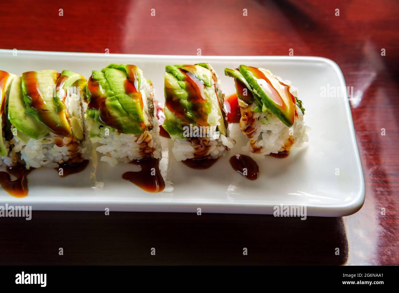 Japanese eel avacado dragon roll with wasabi and pickled ginger Stock ...