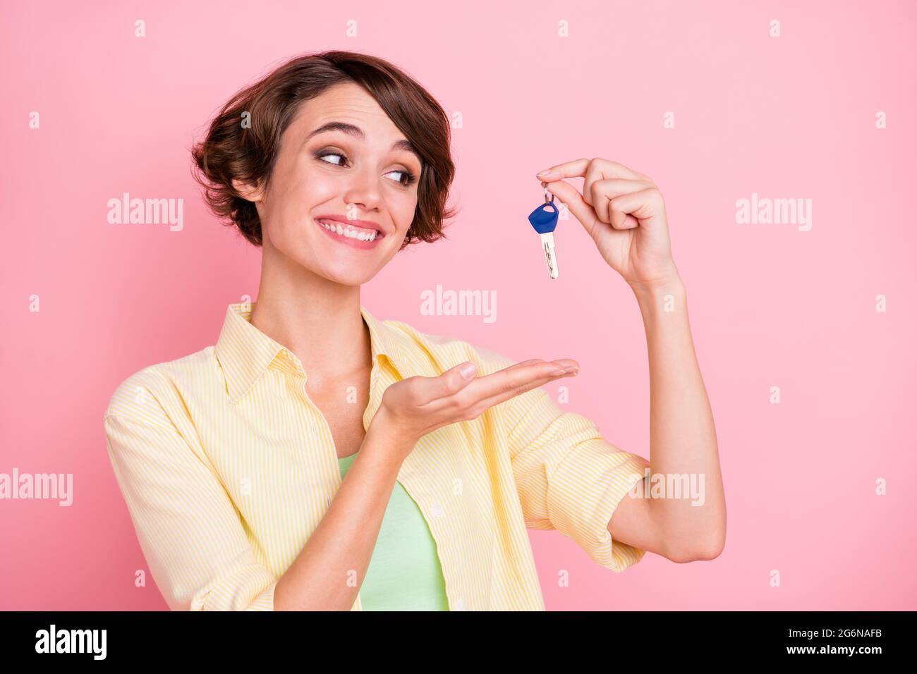 Photo of shiny excited young woman wear yellow shirt holding news house ...