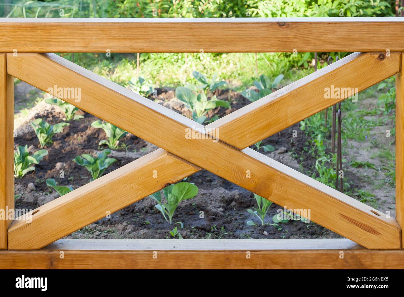 A wooden railing of a balcony with wooden columns isolated on white ...