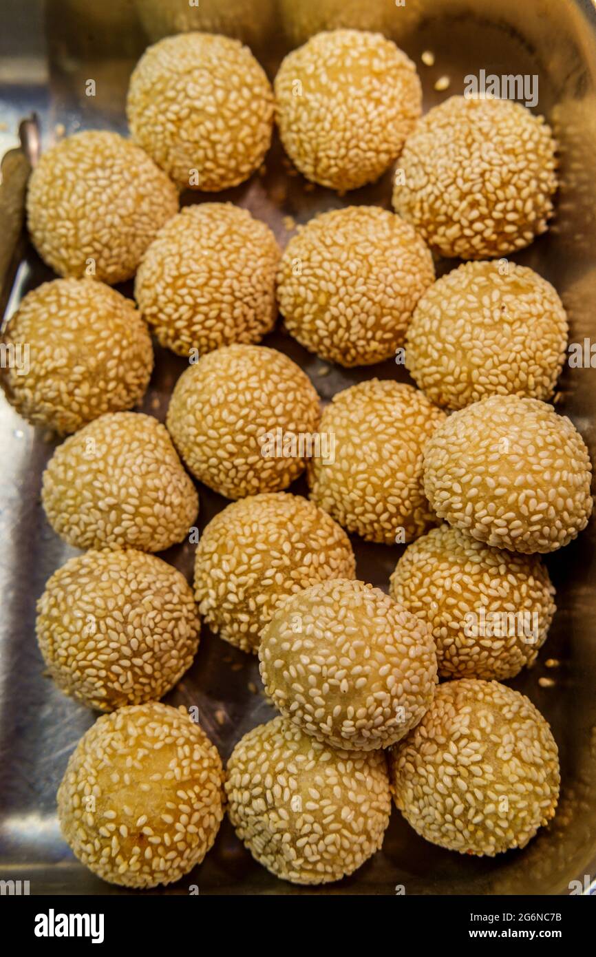 Chinese dessert sesame donuts in self serve buffet tray Stock Photo - Alamy