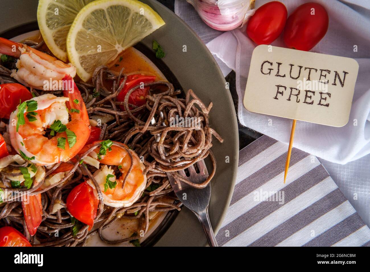 Italian shrimp Gamberoni Aglio e Olio with black pasta and cherry ...