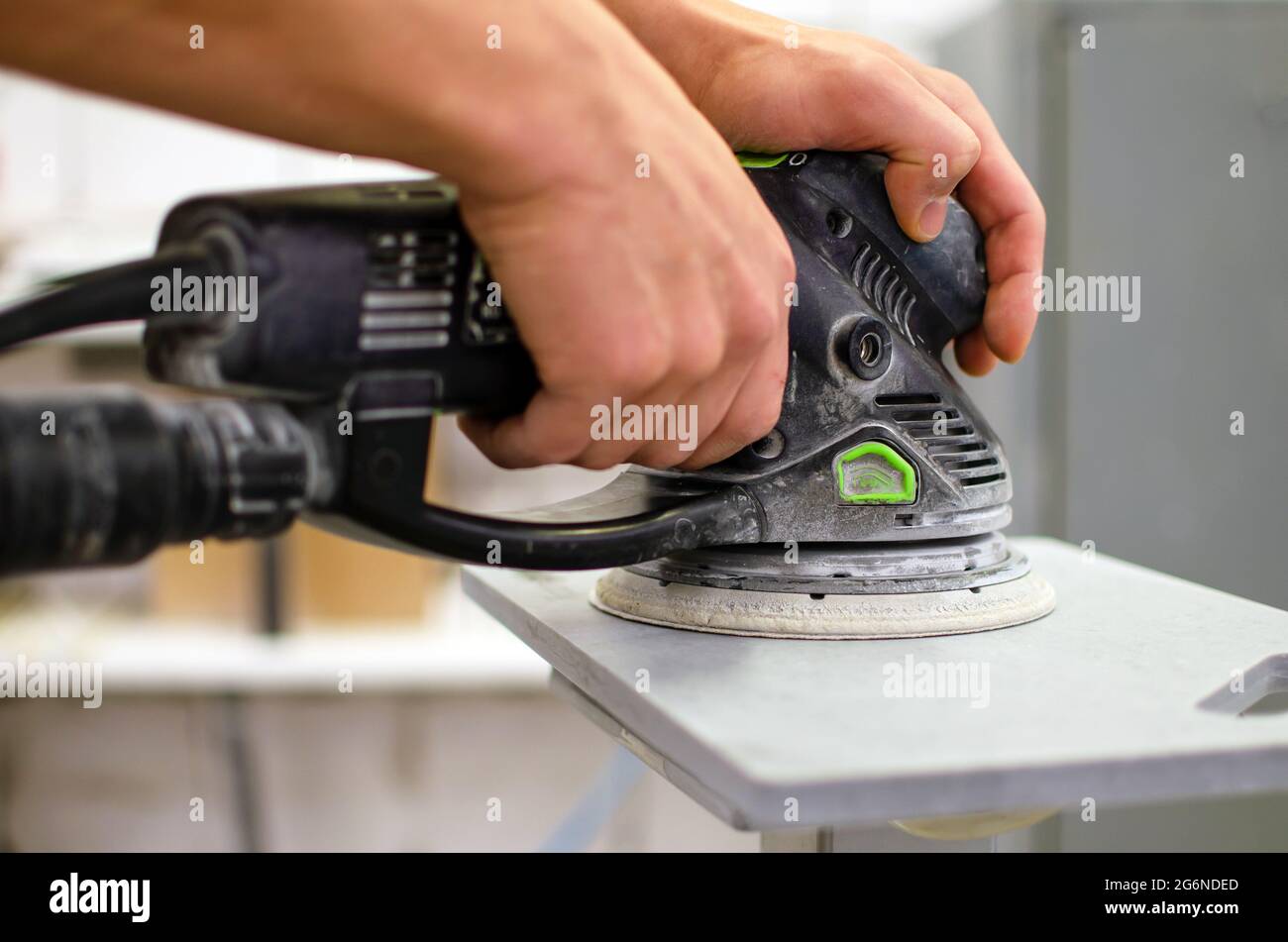 A carpenter works on wood in a carpentry workshop. Grinding tools ...