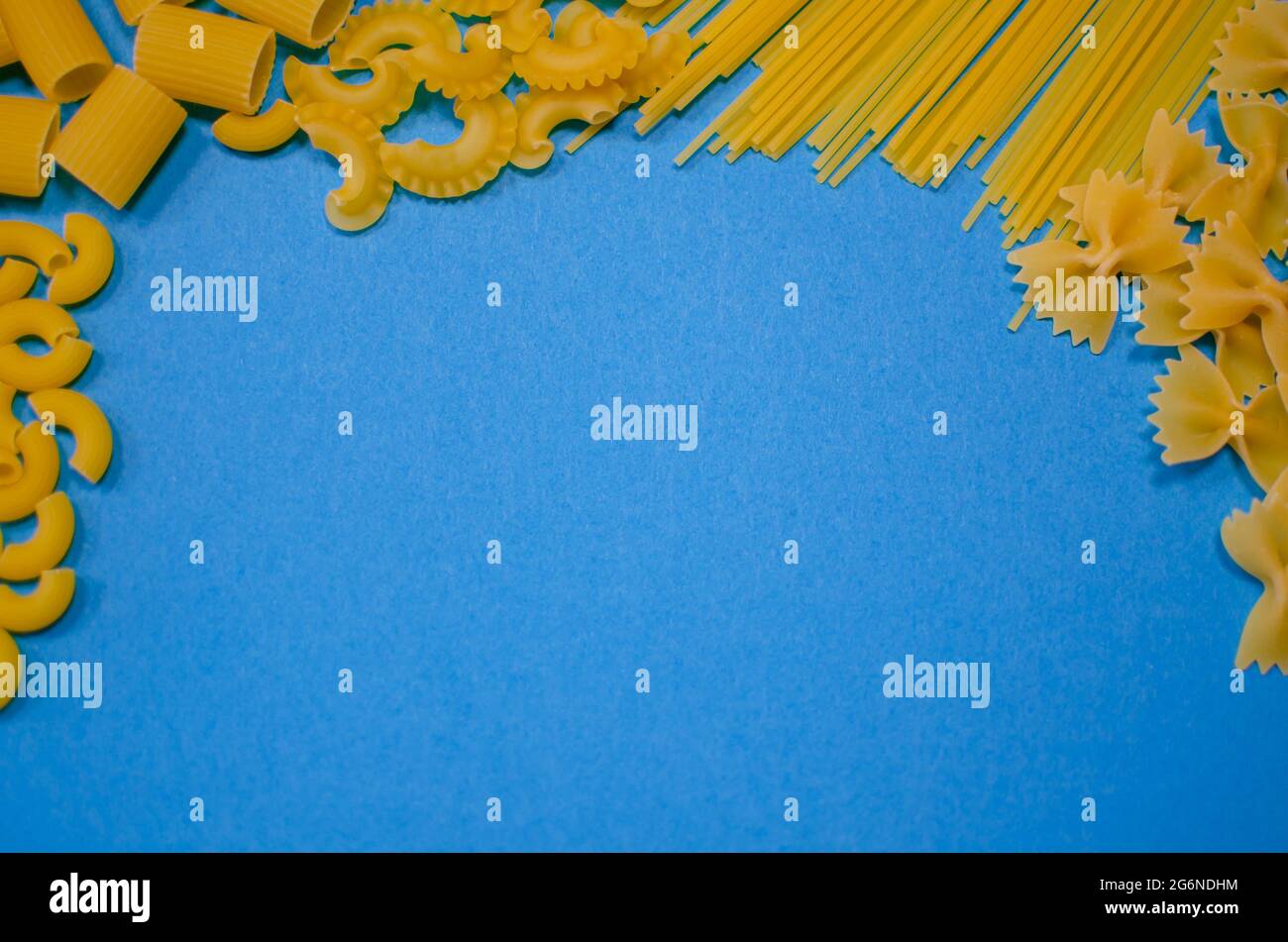 different pasta on a blue background Stock Photo - Alamy