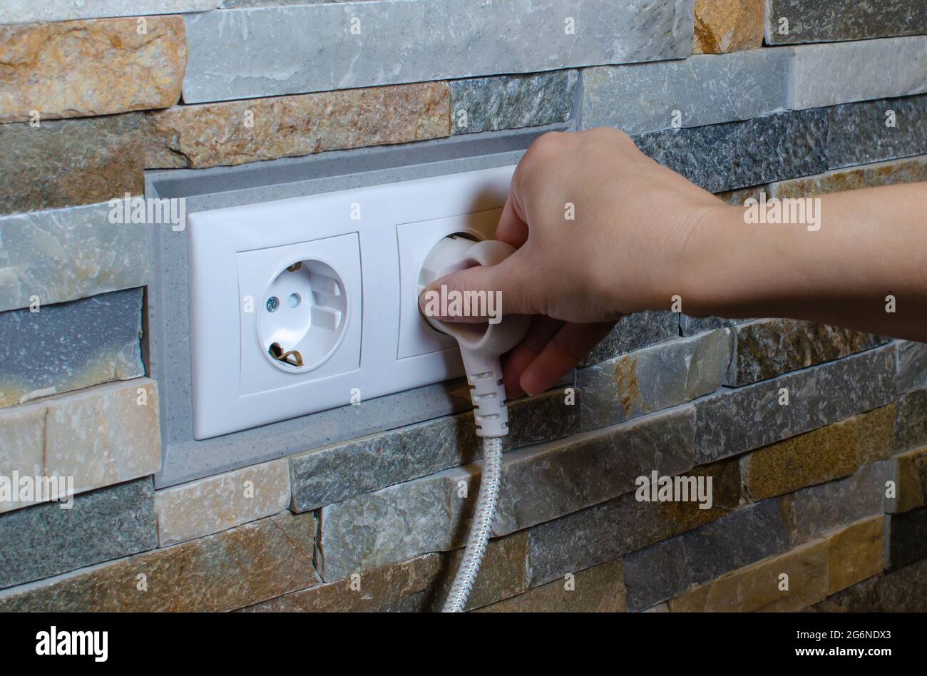 A socket with an electric plug in the wall. Energy saving concept Stock ...