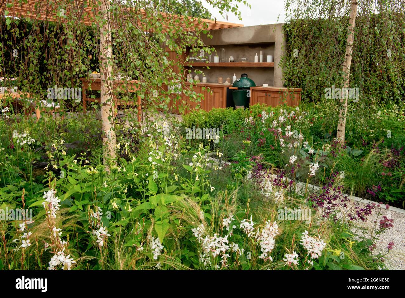 A mixed border of flowering plants and an outdoor kitchen in The Viking ...