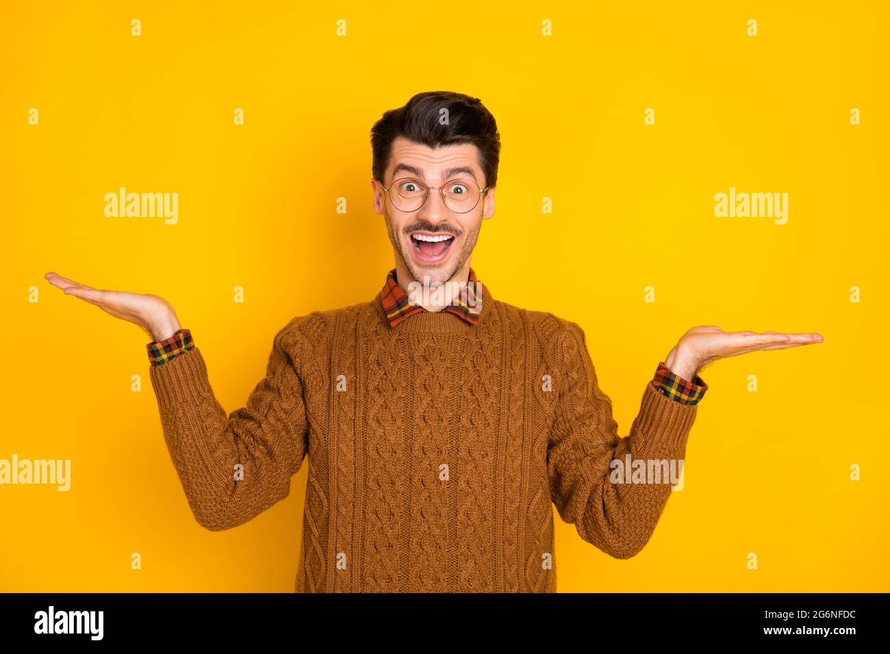 Photo of astonished handsome guy arms palms demonstrate proposition ...