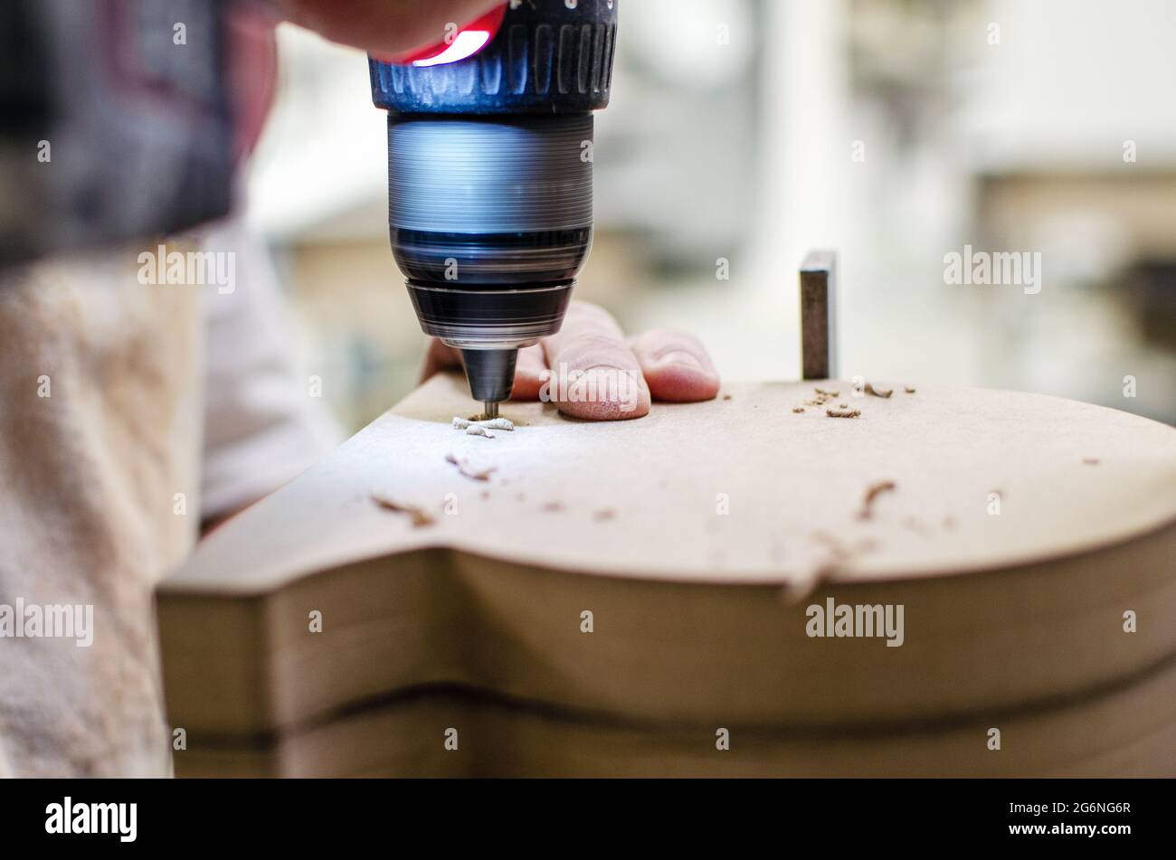 Electric screwdriver. A carpenter works with a hand tool on a work ...