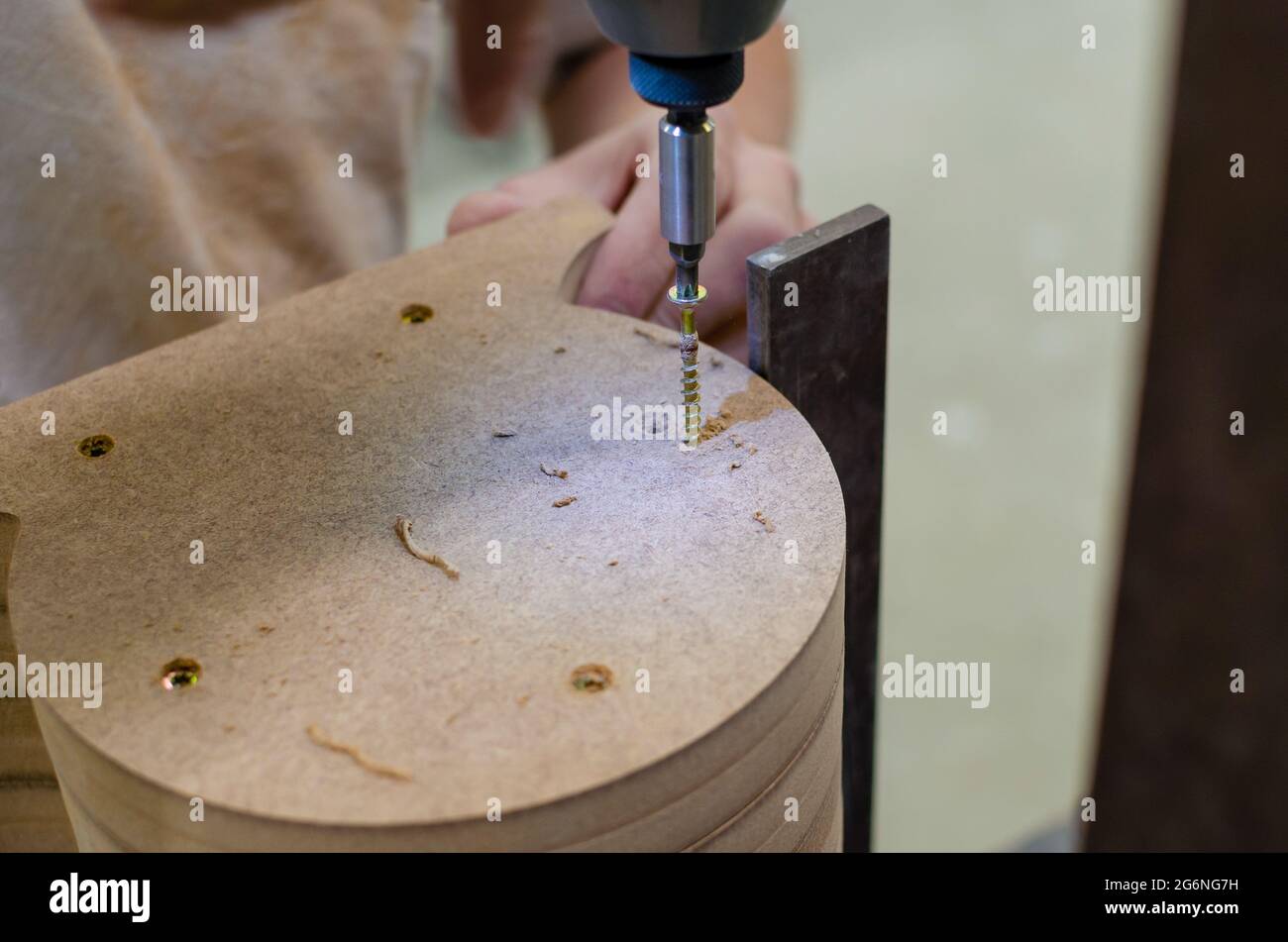 Electric screwdriver. A carpenter works with a hand tool on a work ...