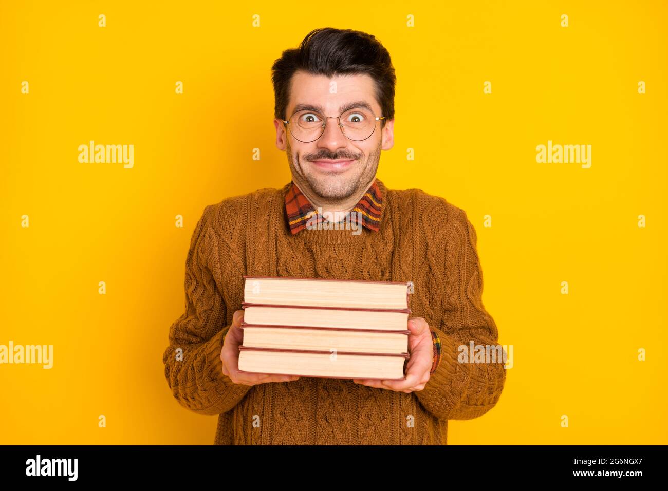 Photo of funny geek guy hold stack book shrug shoulders wear specs ...