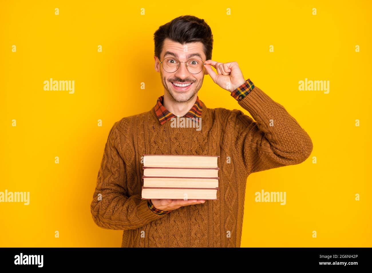 Photo of smart charming man hold pile books materials test prepare ...