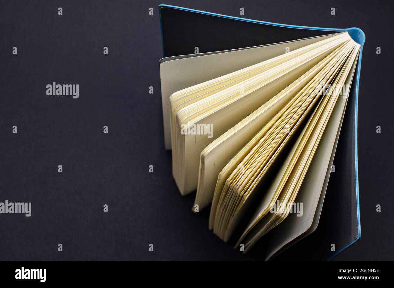 An open book with a blue leather cover. View from above. Education ...