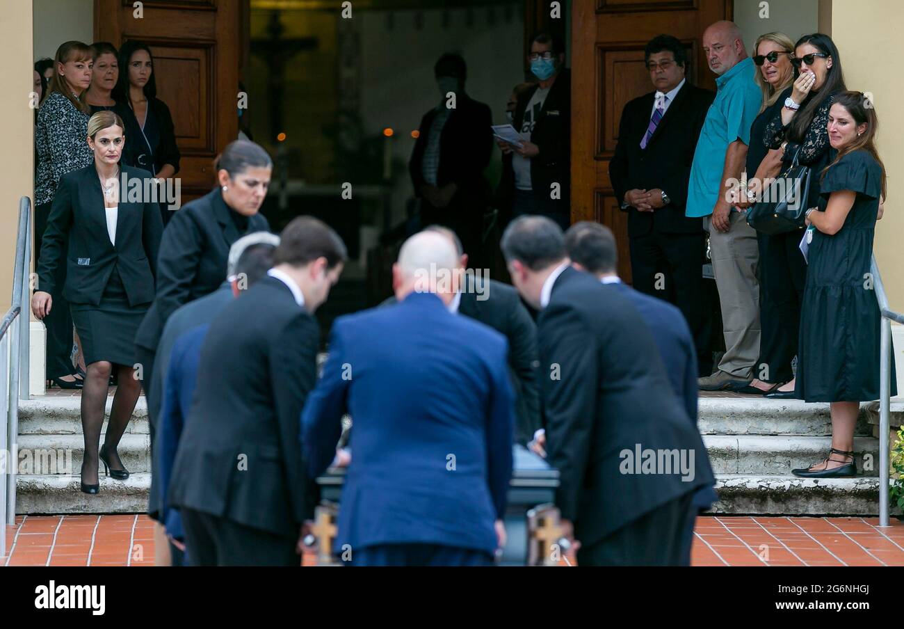 Pallbearers wheel the casket of Marcus Guara as they arrive to his ...