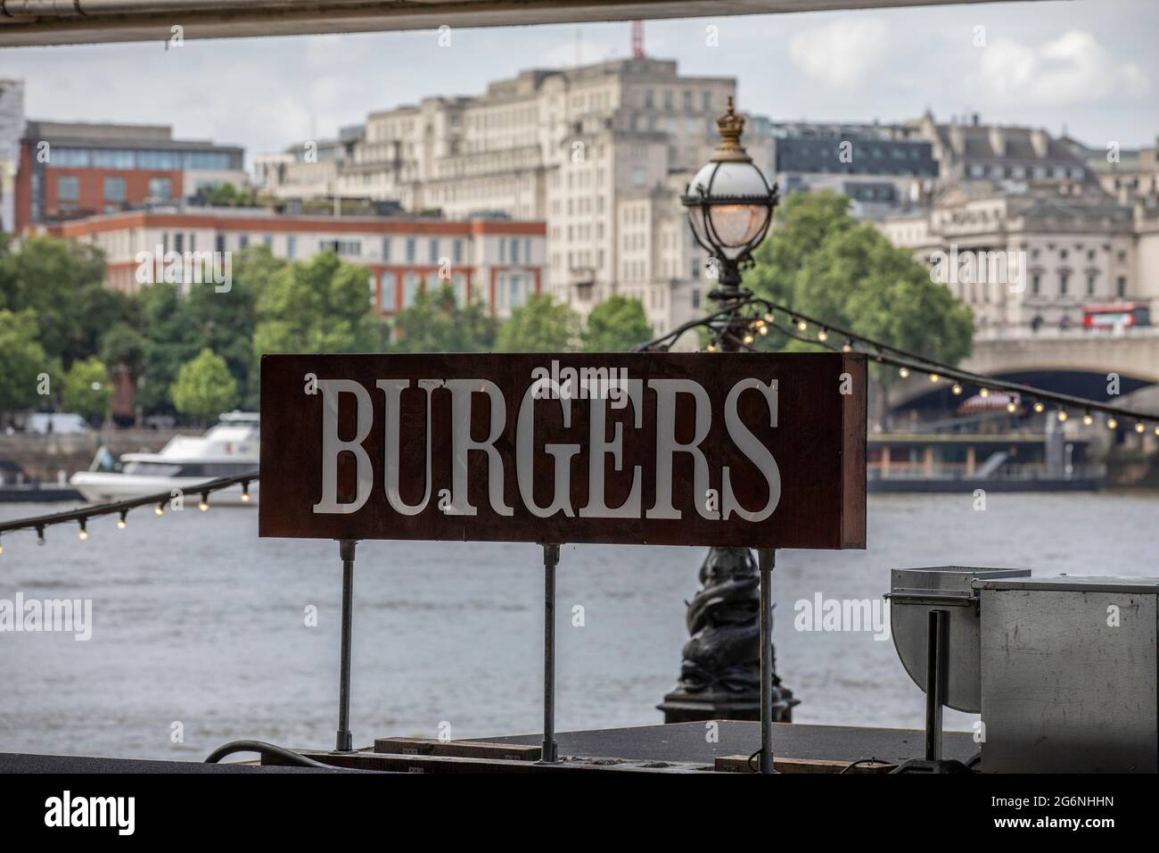 'Burger' sign with the River Thames and buildings in the Embankment ...