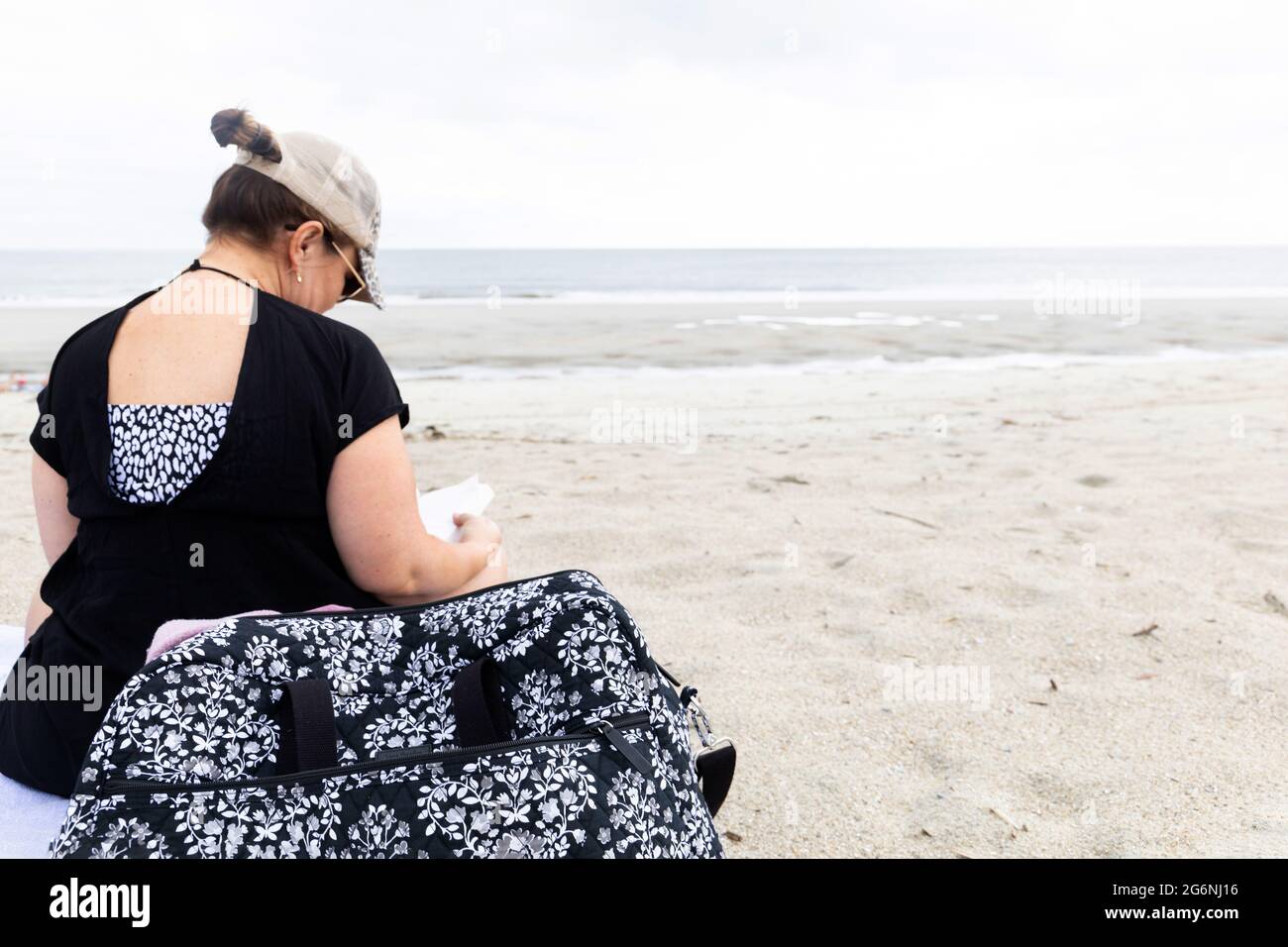 Female sitting on beach alone hi-res stock photography and images - Alamy