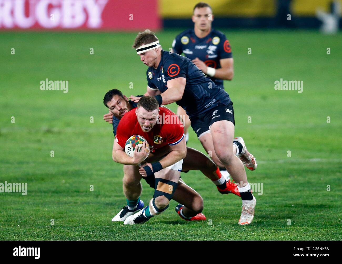 Marius Louw and James Venter of the Cell C Sharks tackle Sam Simmonds ...