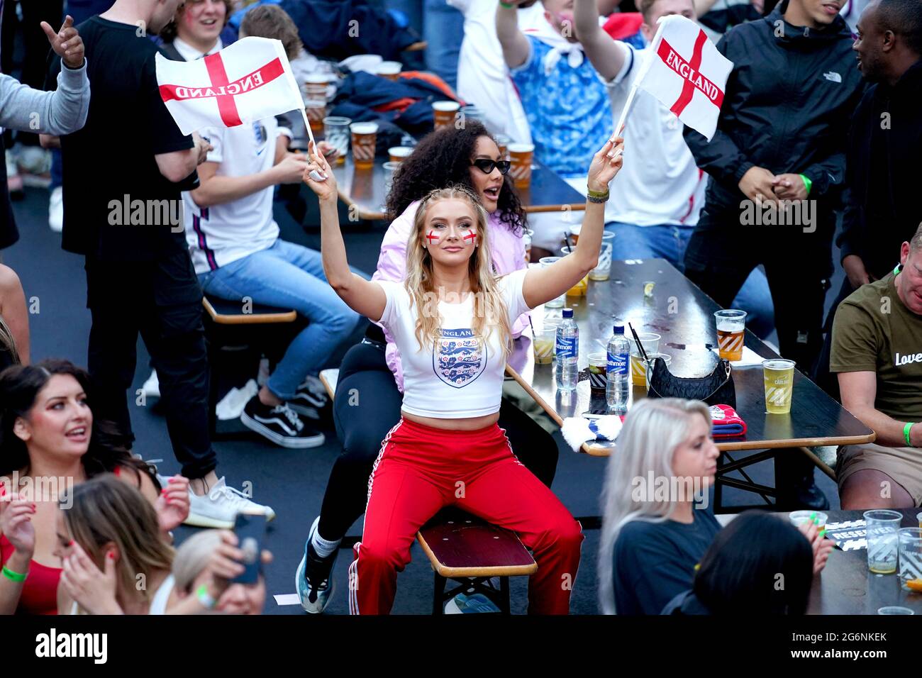 An England fan waves flags at BOXPARK in Croydon as they watch the Euro ...