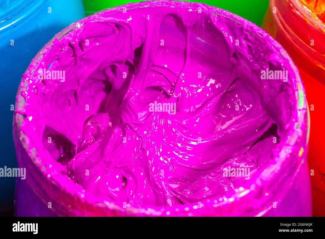 close up pink color of ink for print tee shirt in the transparent glass ...