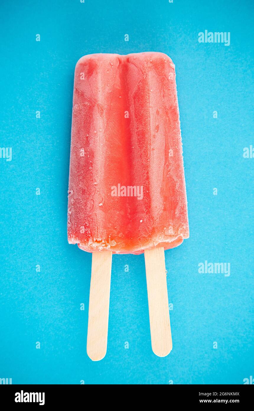 Red Popsicle on a Blue Background Stock Photo - Alamy