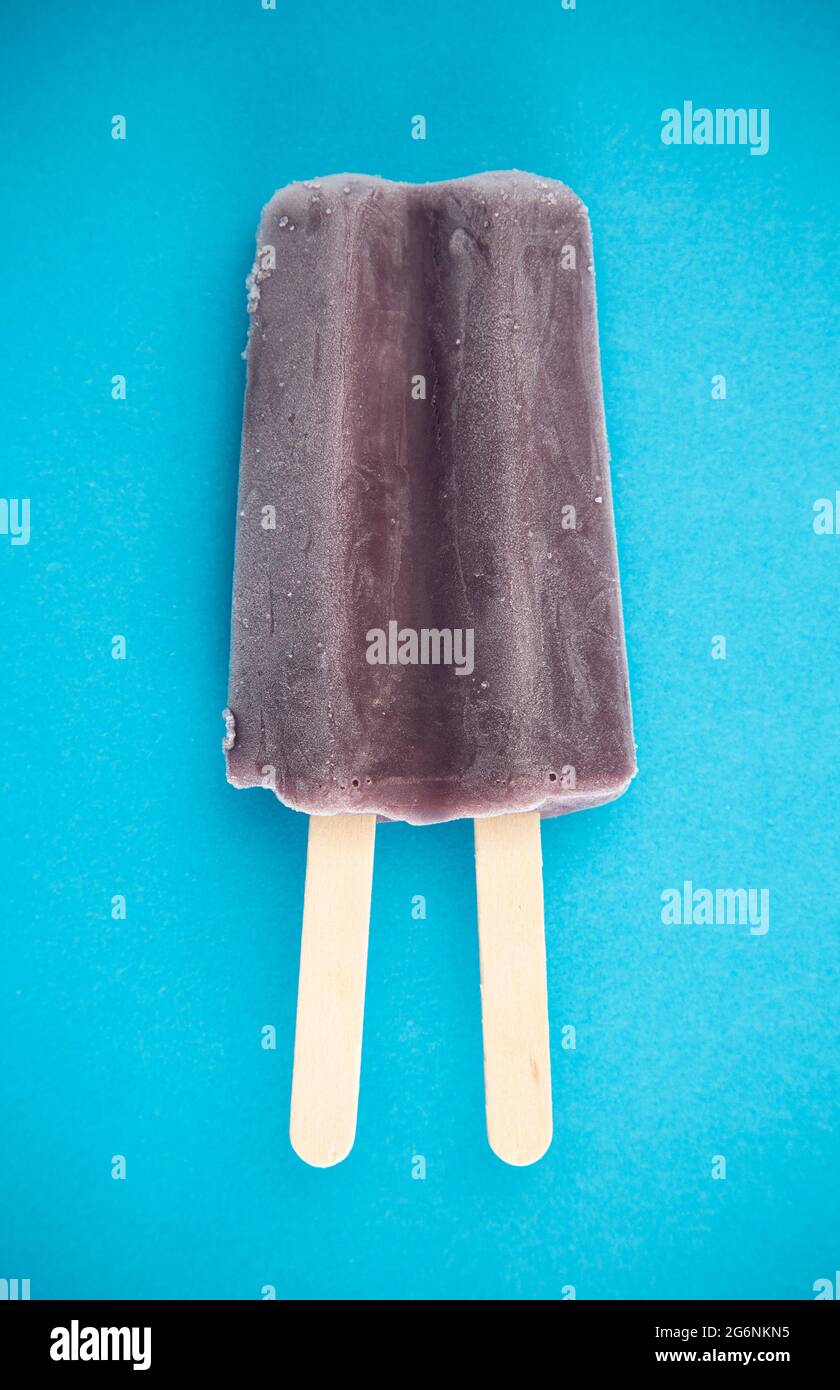 Purple Popsicle on a Blue Background Stock Photo - Alamy