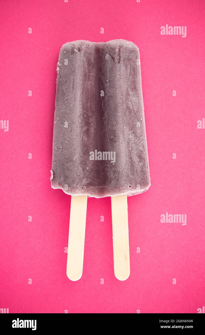 Purple Popsicle on a Bright Pink Background Stock Photo - Alamy