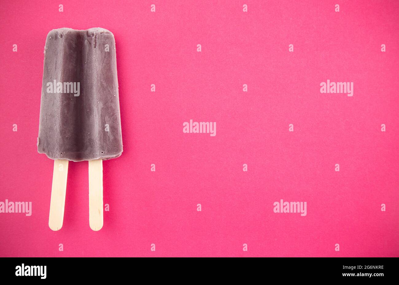 Purple Popsicle on a Bright Pink Background Stock Photo - Alamy
