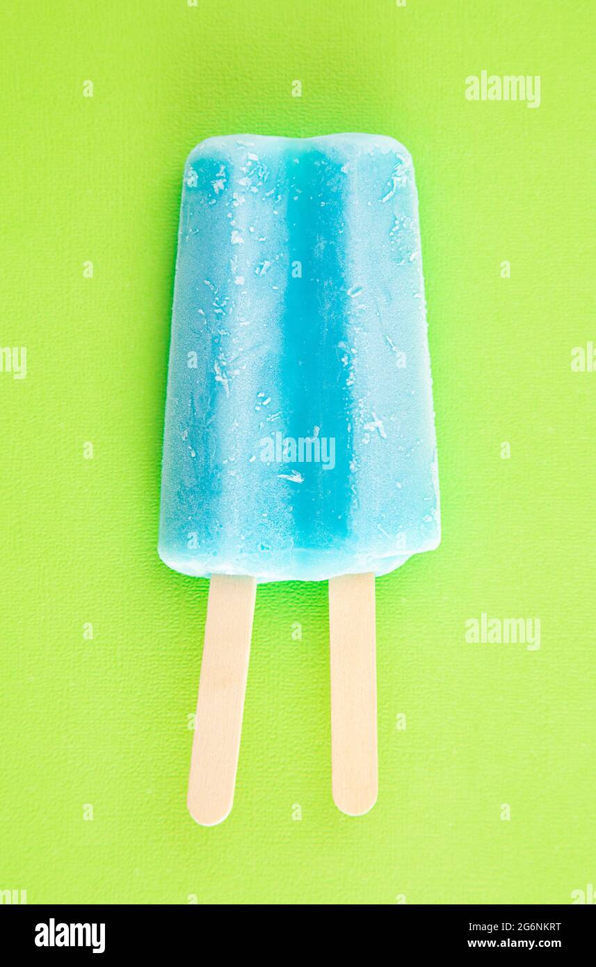 Blue Popsicle on a Bright Green Background Stock Photo - Alamy