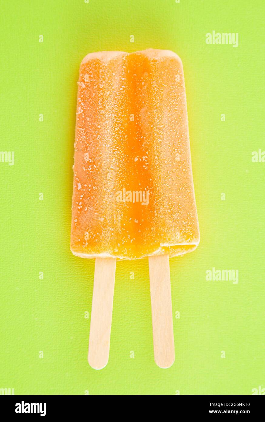 Orange Popsicle on a Bright Green Background Stock Photo - Alamy