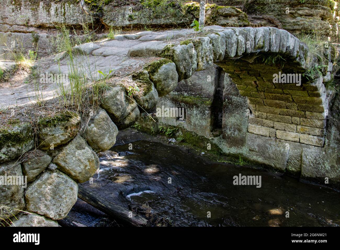Old stone bridge over a stream in the woods Stock Photo - Alamy