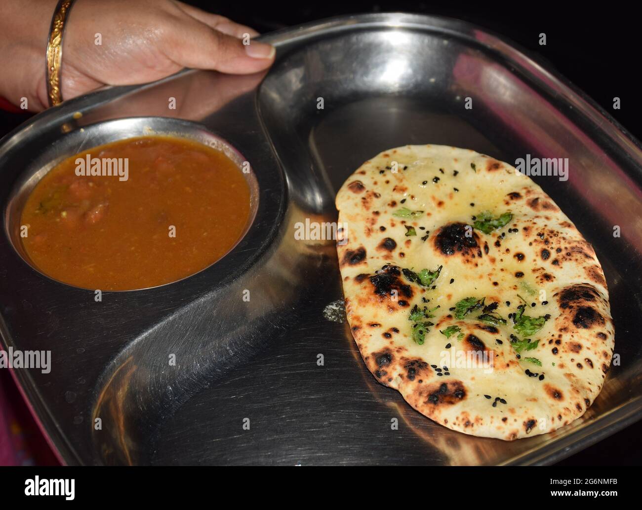 An Indian Butter Naan thali with Rajma is being served Stock Photo - Alamy