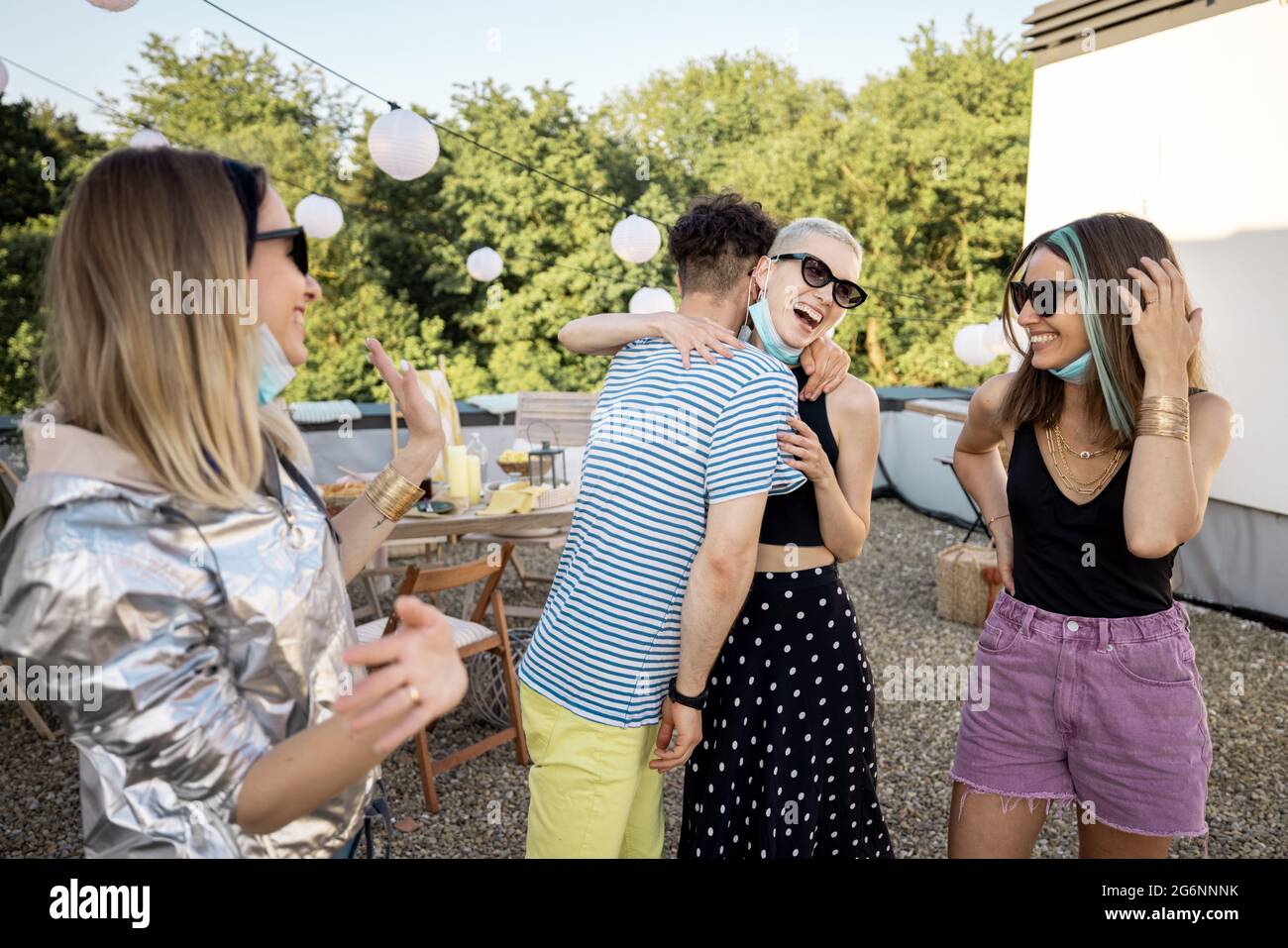 Friends in face masks gathering on a party outdooors Stock Photo - Alamy