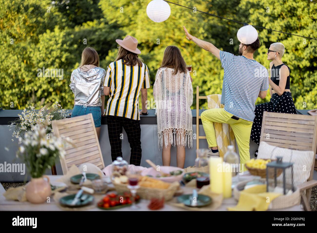 Friends at party on the roof terrace Stock Photo - Alamy