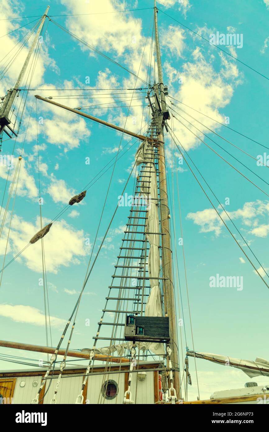 Wooden mast and ropes of sailboat, View of the ship's masts from below ...