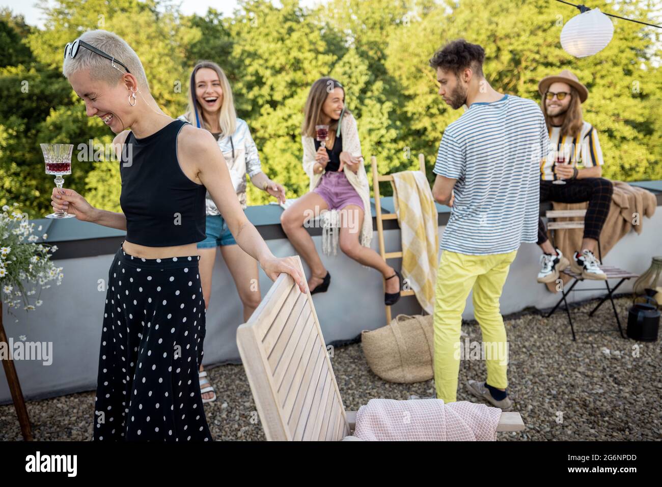 Stylish friends at party on the roof terrace Stock Photo - Alamy