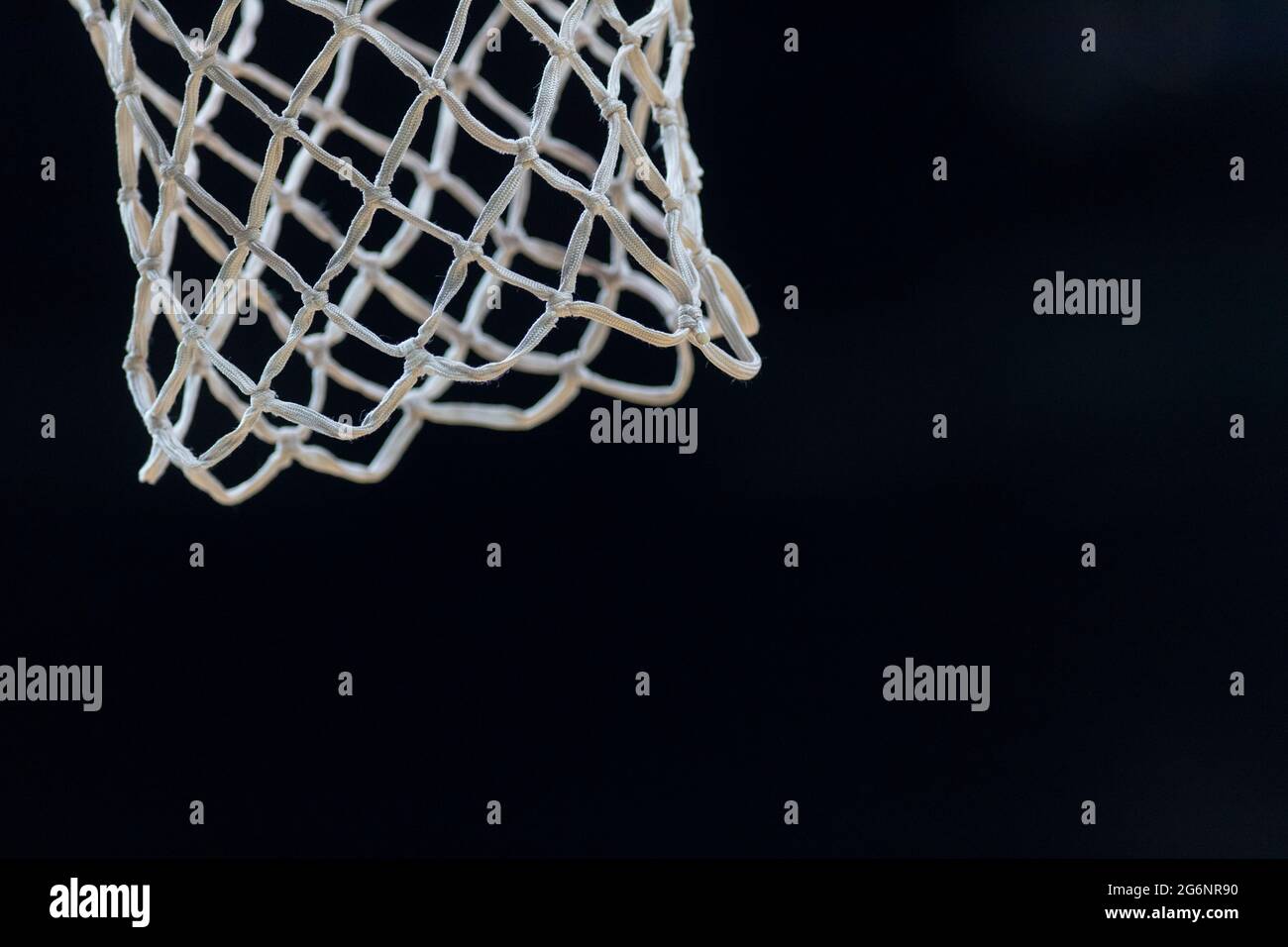 Empty swooshing basketball net close up with dark background ...