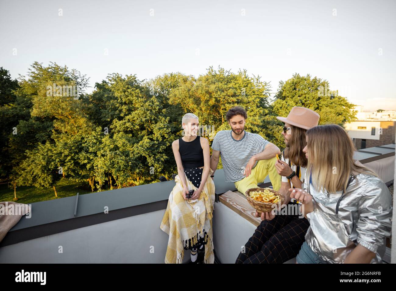 Friends hang out together at rooftop on a sunset Stock Photo - Alamy