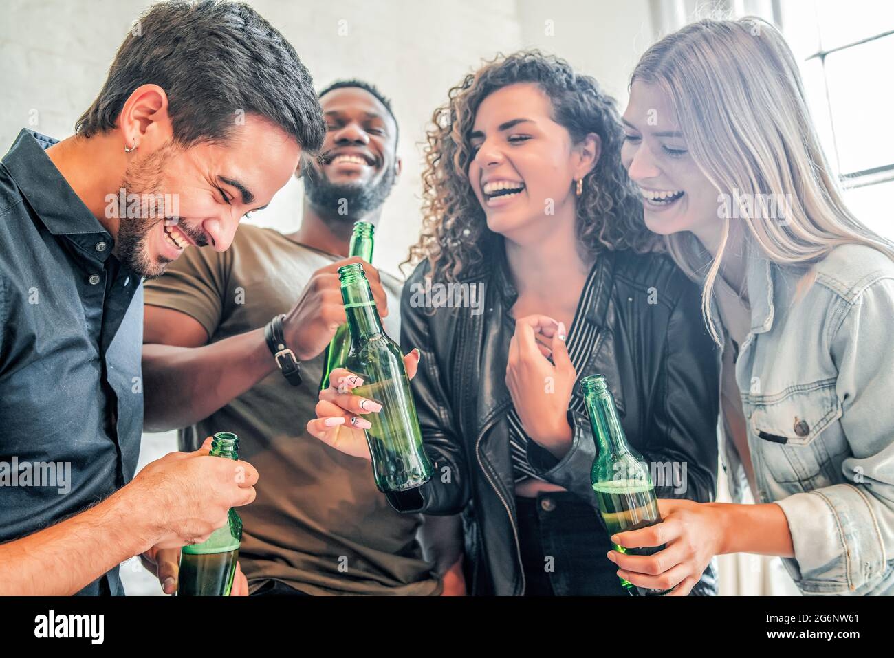 Friends having fun while drinking beer together Stock Photo - Alamy