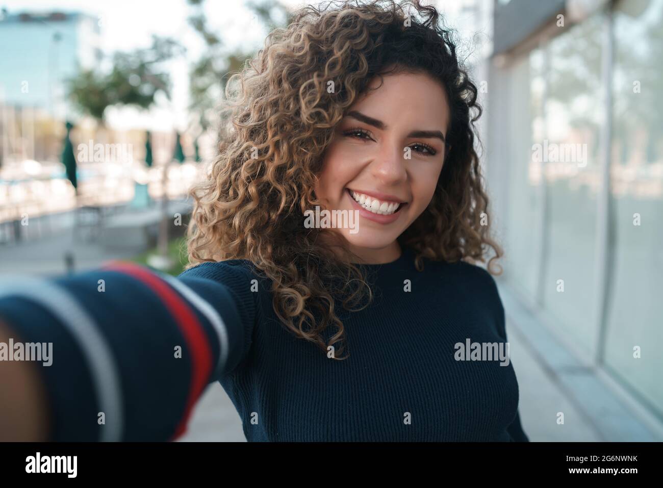 Young woman taking selfies outdoors Stock Photo - Alamy