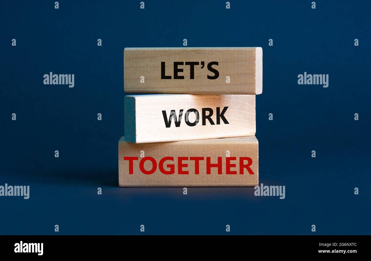Work together symbol. Wooden blocks with words Let is work together on ...