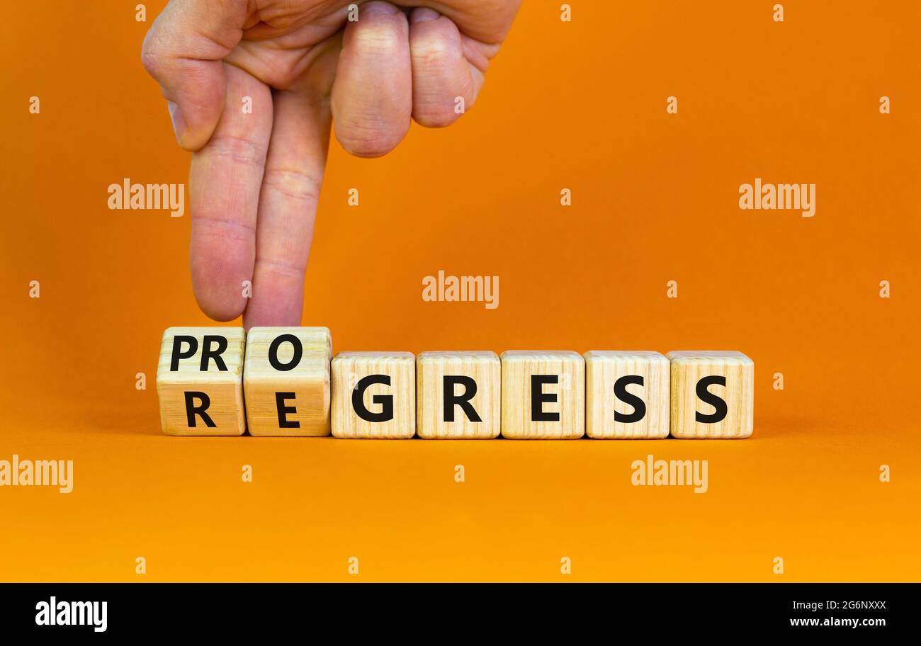 Regress or progress symbol. Businessman turns wooden cubes and changes ...