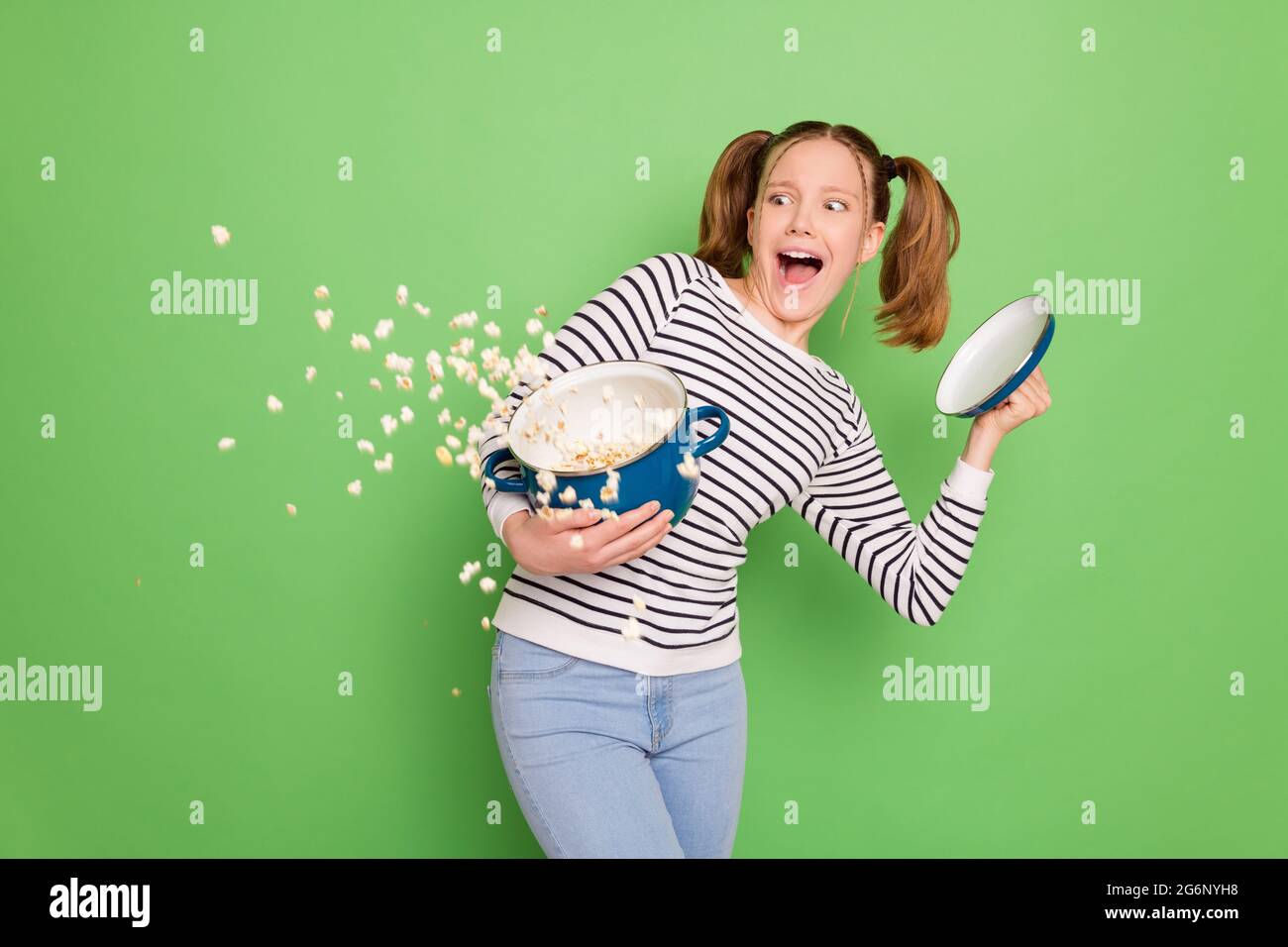 Photo of shocked funky school girl wear white pullover cooking pop-corn ...