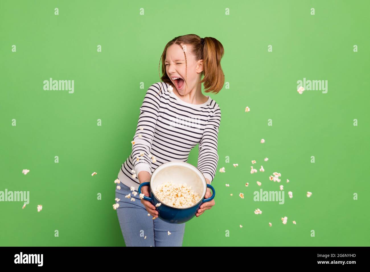 Photo of impressed funny small schoolgirl dressed striped sweater ...